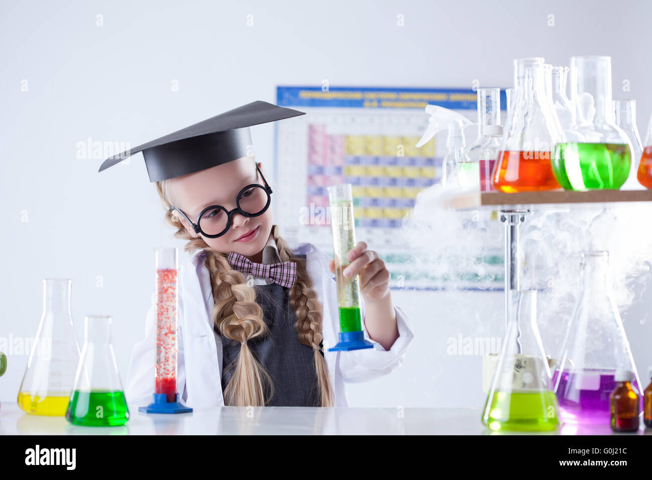 Studio shot of little girl posing in chemistry lab Stock Photo - Alamy