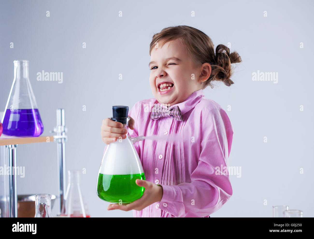 Image of cute little girl posing with heavy flask Stock Photo - Alamy