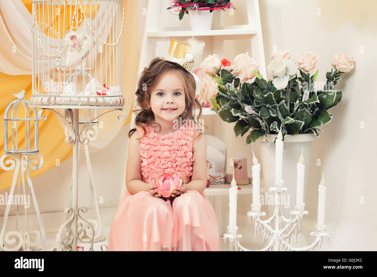 Beautiful little lady posing in vintage interior Stock Photo - Alamy
