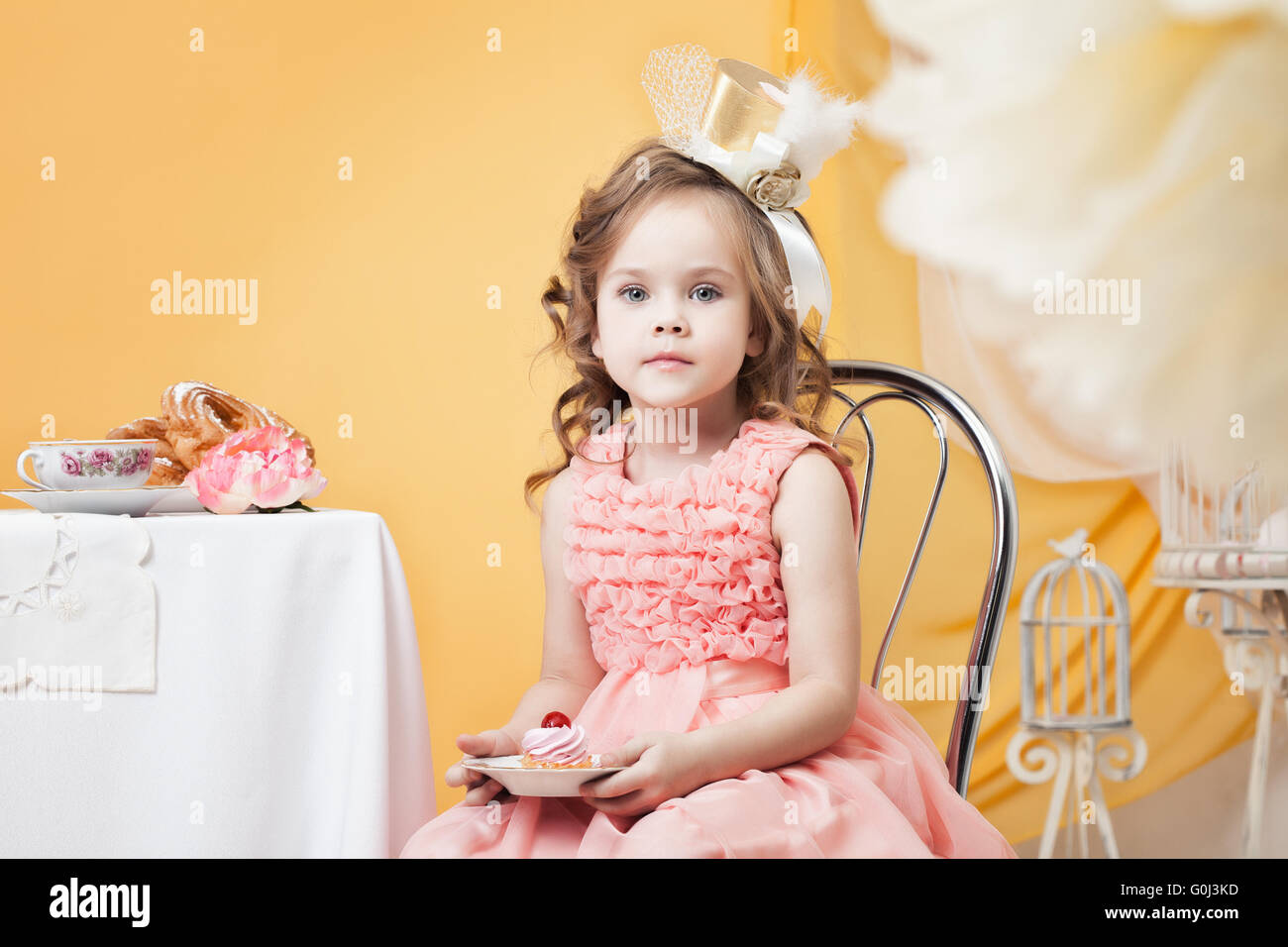 Thoughtful girl posing with cake in retro interior Stock Photo - Alamy