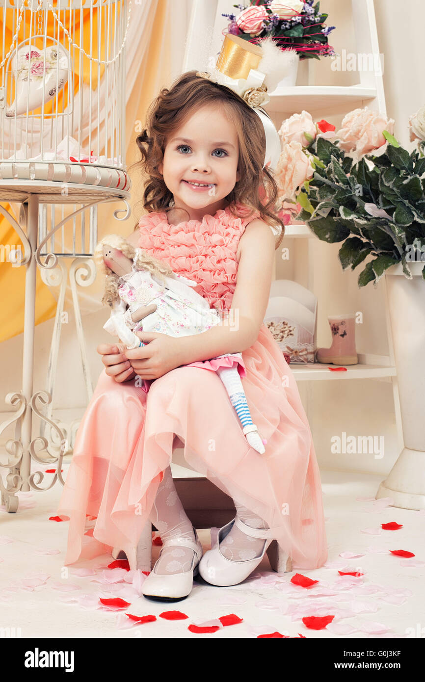 Fancy model posing with doll in retro interior Stock Photo - Alamy