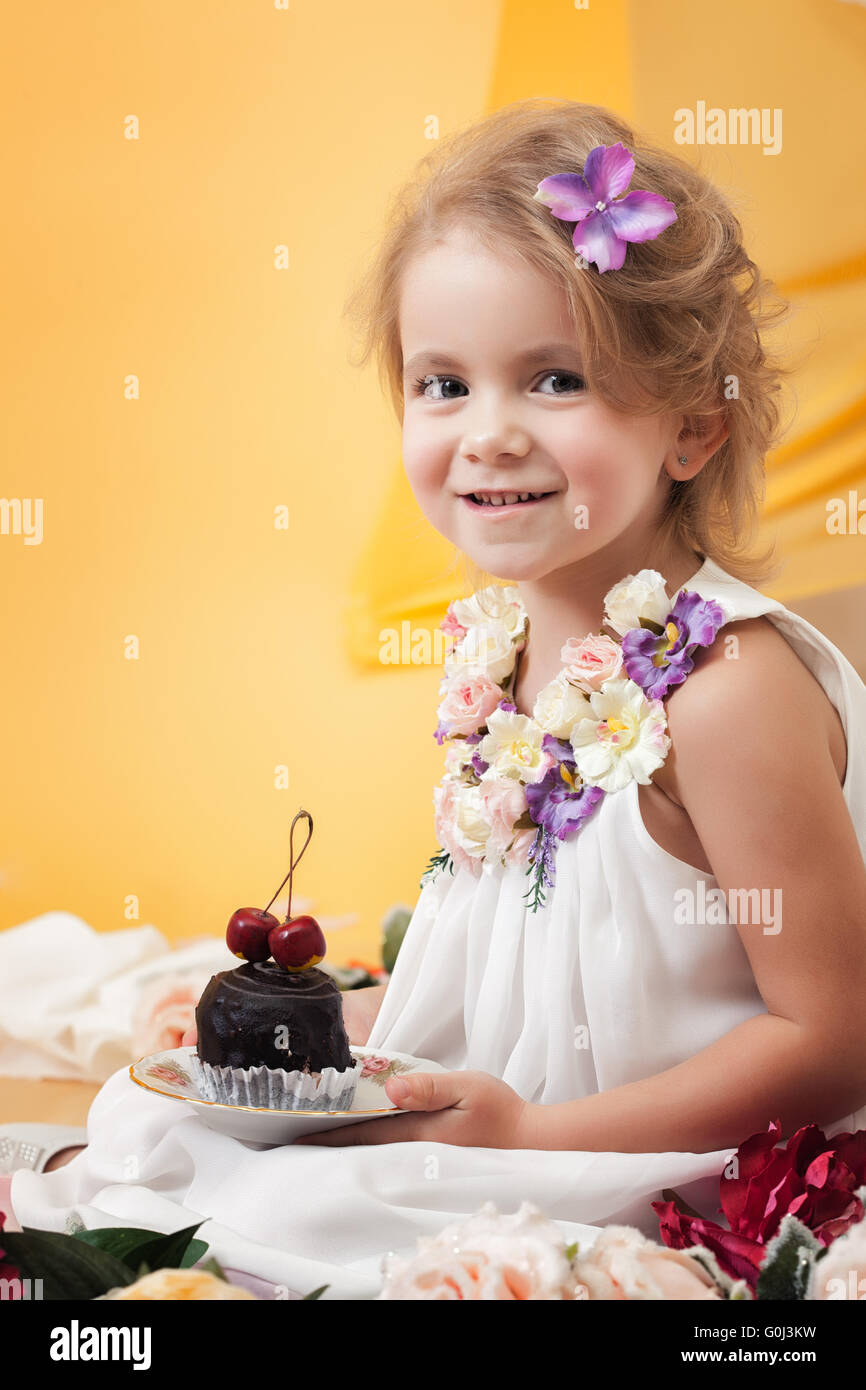 Pretty little girl posing with chocolate cake Stock Photo - Alamy