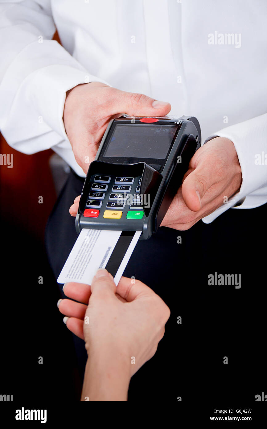dinner in restaurant man and woman pay by credit card Stock Photo - Alamy