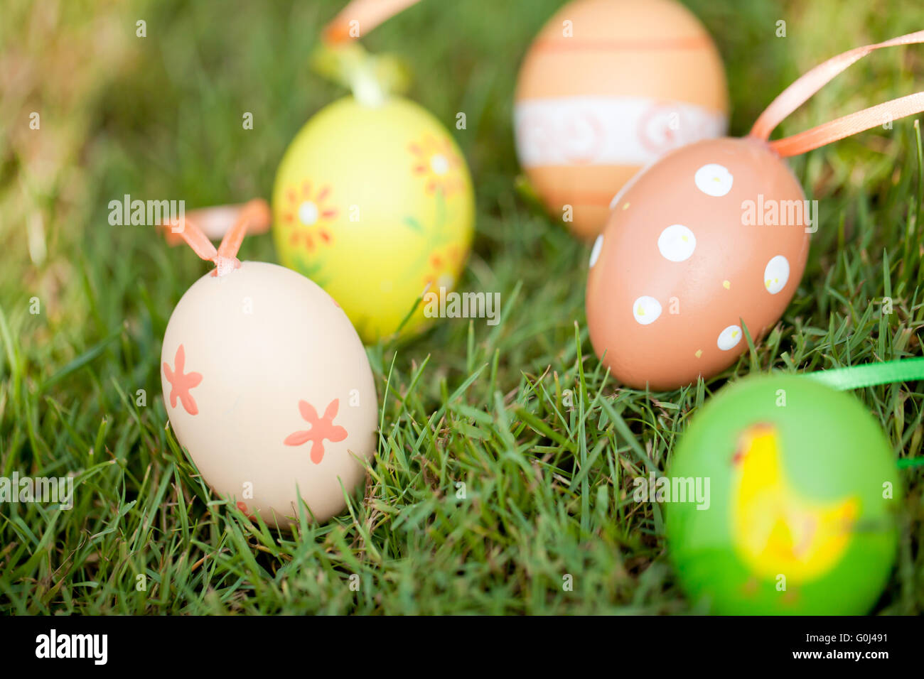 colored easter eggs group in green grass outdoor in spring Stock Photo ...