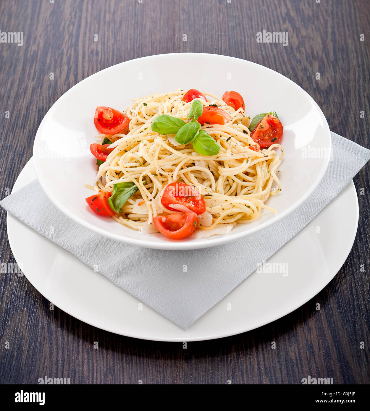 fresh tasty pasta spaghetti with tomatoes and basil Stock Photo - Alamy