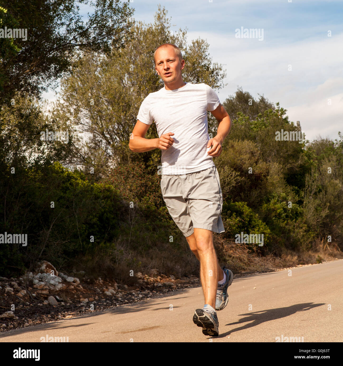 athletic man runner jogging in nature outdoor Stock Photo - Alamy