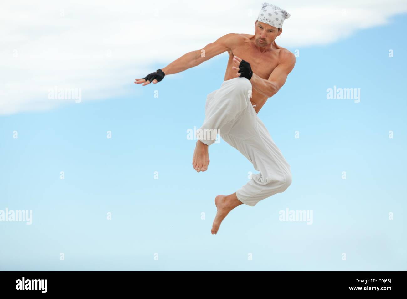 man is jumping sport karate martial arts fight kick Stock Photo - Alamy