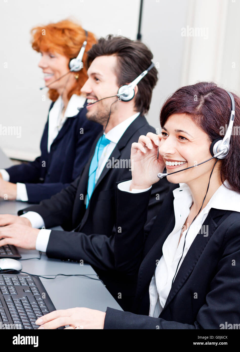 smiling callcenter agent with headset support Stock Photo - Alamy