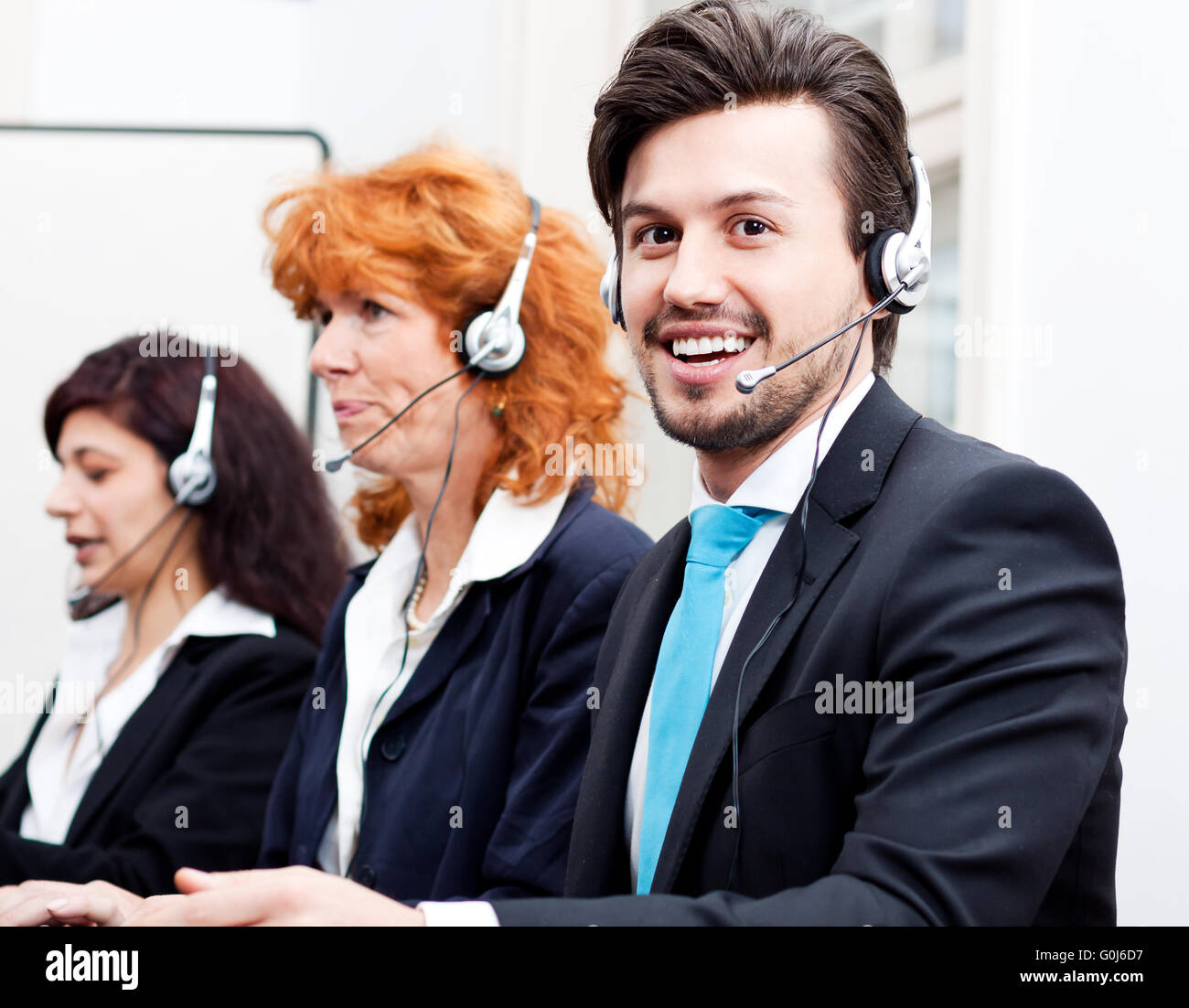 smiling callcenter agent with headset support Stock Photo - Alamy