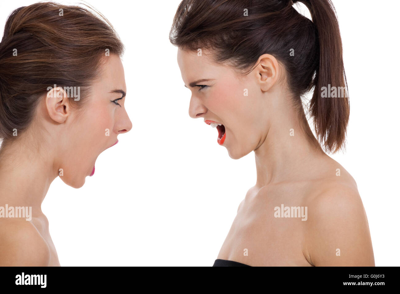 two young girls angry shouting loud isolated Stock Photo - Alamy