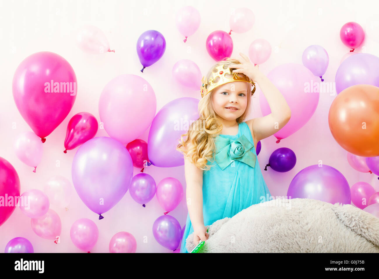 Image of comely little girl tries on toy crown Stock Photo - Alamy