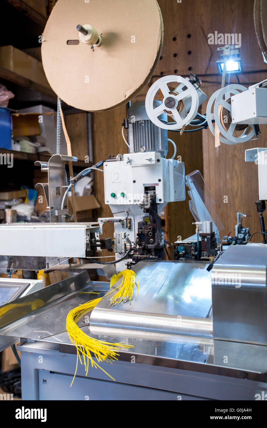 Manufacturing facility. Crimped wires on machine Stock Photo - Alamy
