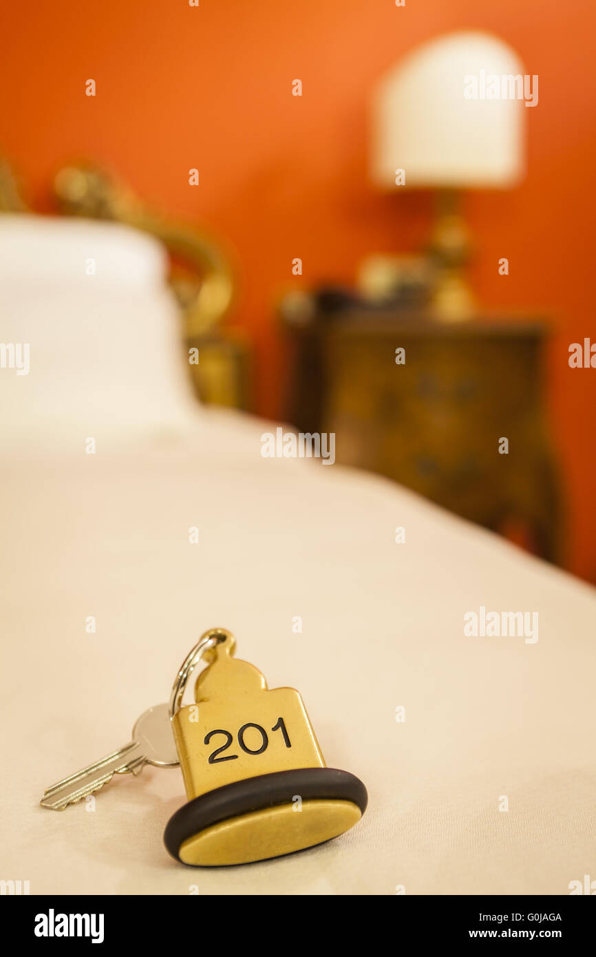Hotel Room Key lying on Bed with keyring Stock Photo - Alamy