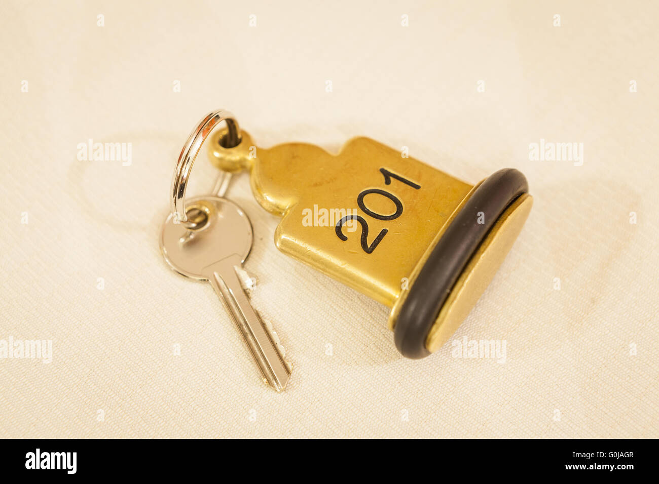 Hotel Room Key lying on Bed with keyring Stock Photo - Alamy