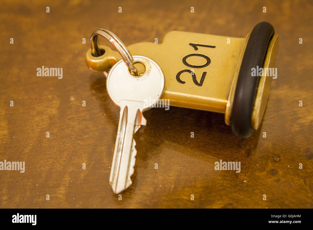 Hotel Room Key lying on Bed with keyring Stock Photo - Alamy