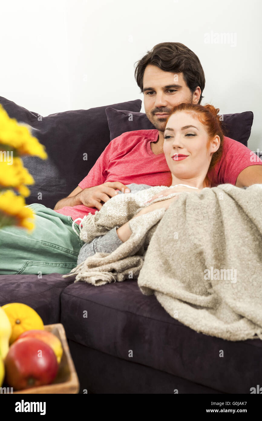 Couple Resting on the Sofa at the Living Room Stock Photo - Alamy