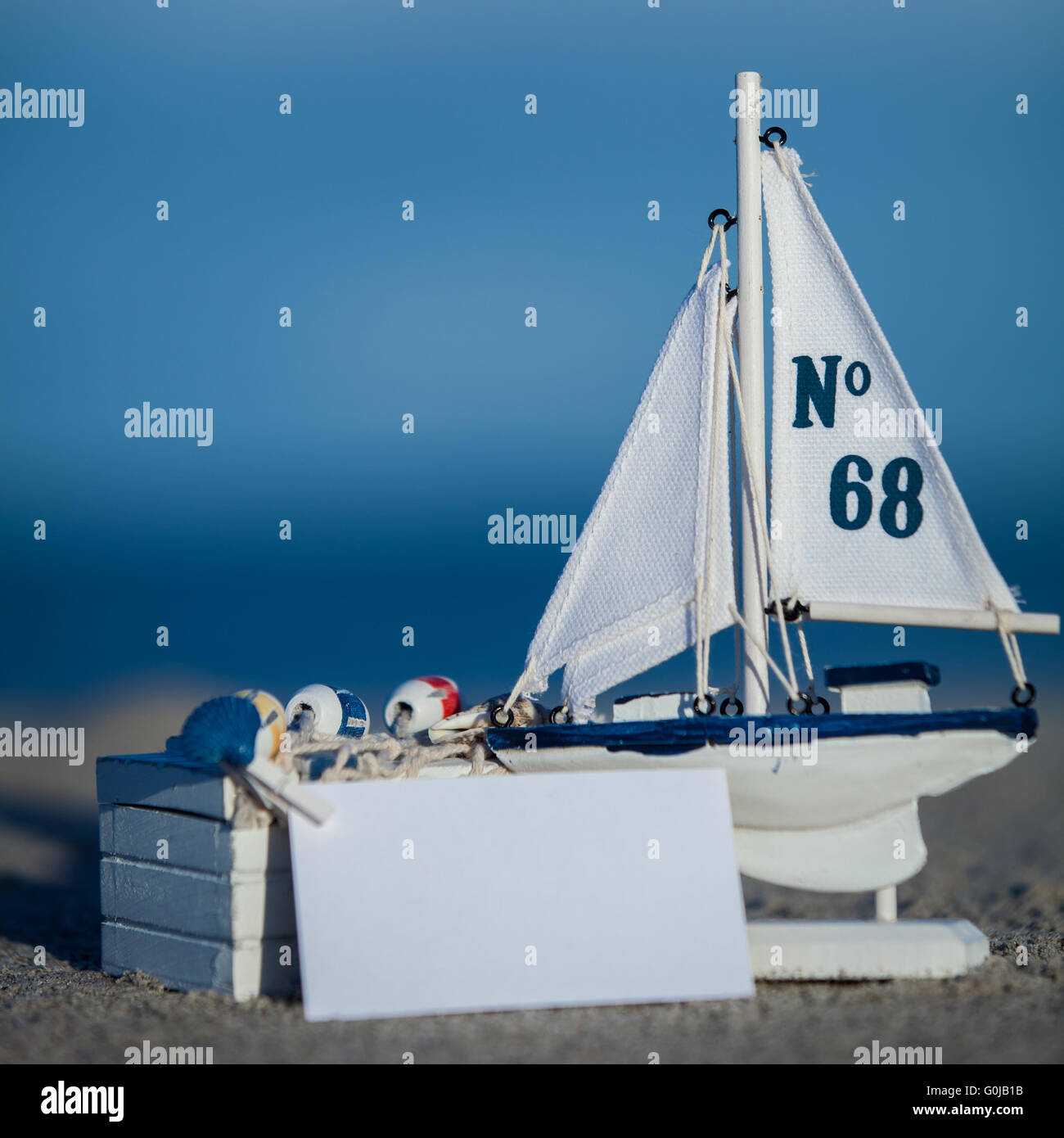 sailing boat and seashell in sand decoration closeup Stock Photo - Alamy