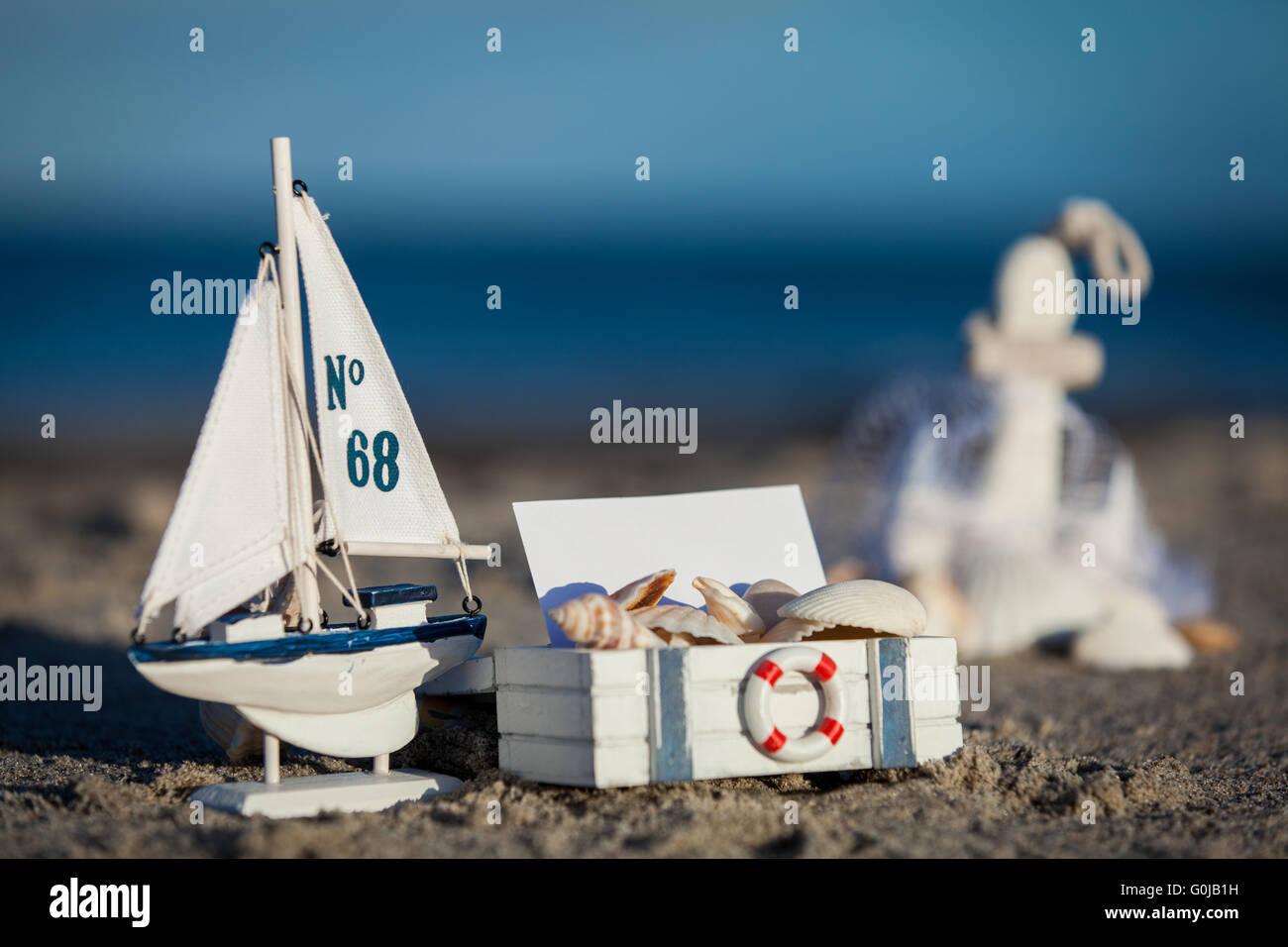 sailing boat and seashell in sand decoration closeup Stock Photo - Alamy