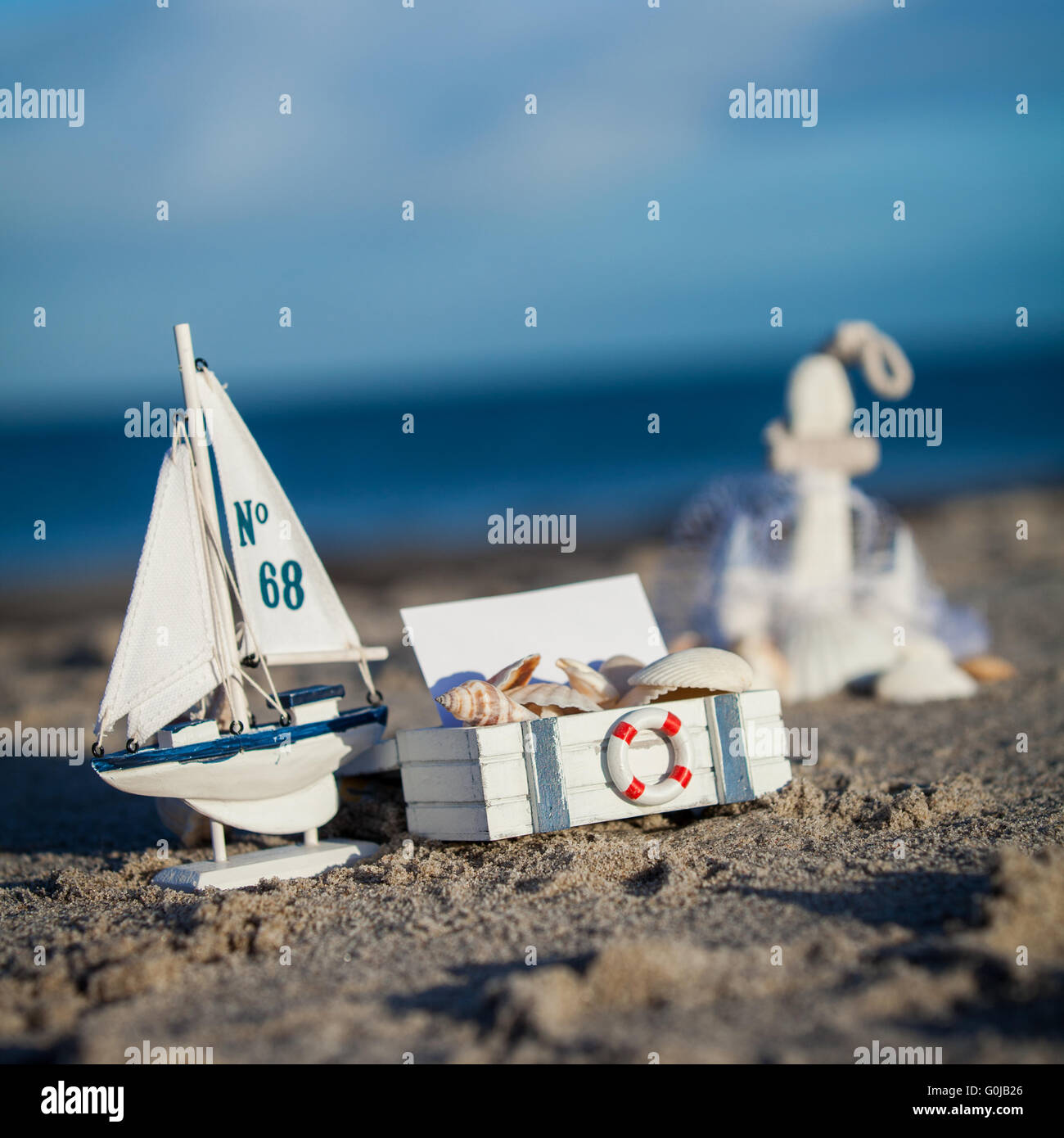 sailing boat and seashell in sand decoration closeup Stock Photo - Alamy