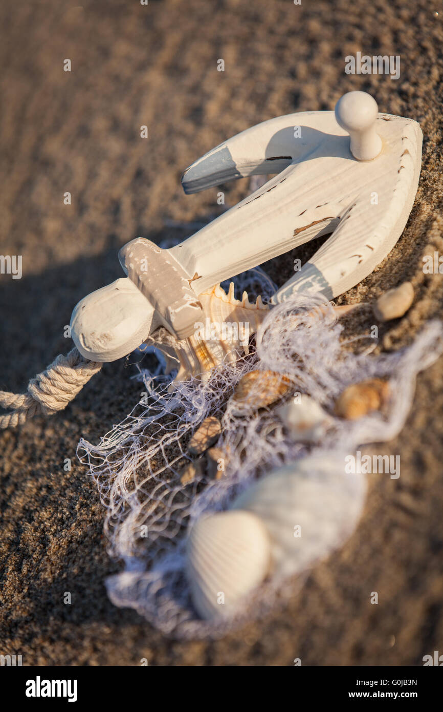 sailing boat and seashell in sand decoration closeup Stock Photo - Alamy
