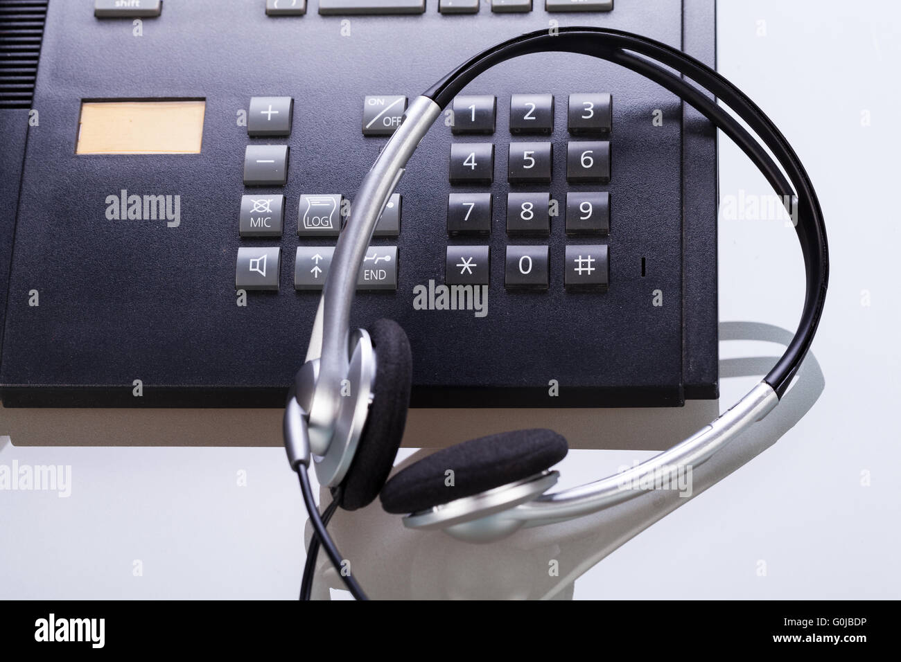 office desk with telephone and headset objects Stock Photo - Alamy