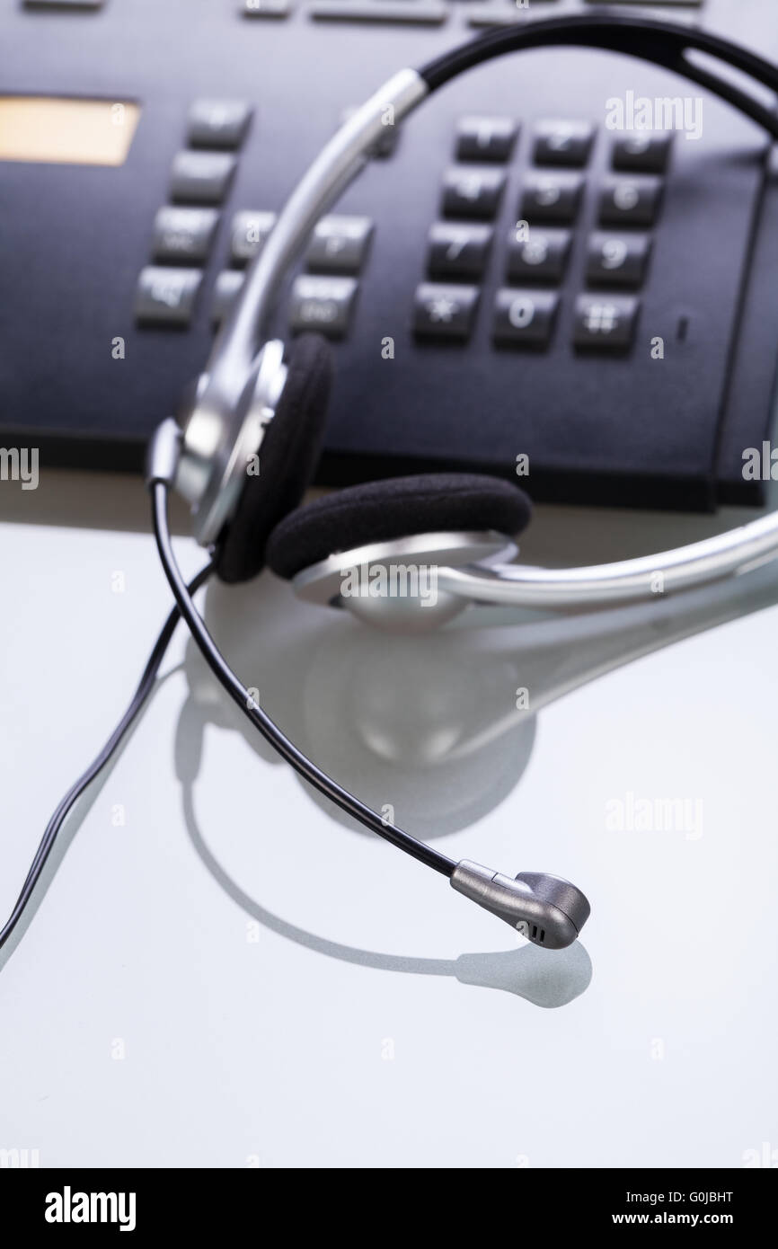 office desk with telephone and headset objects Stock Photo - Alamy