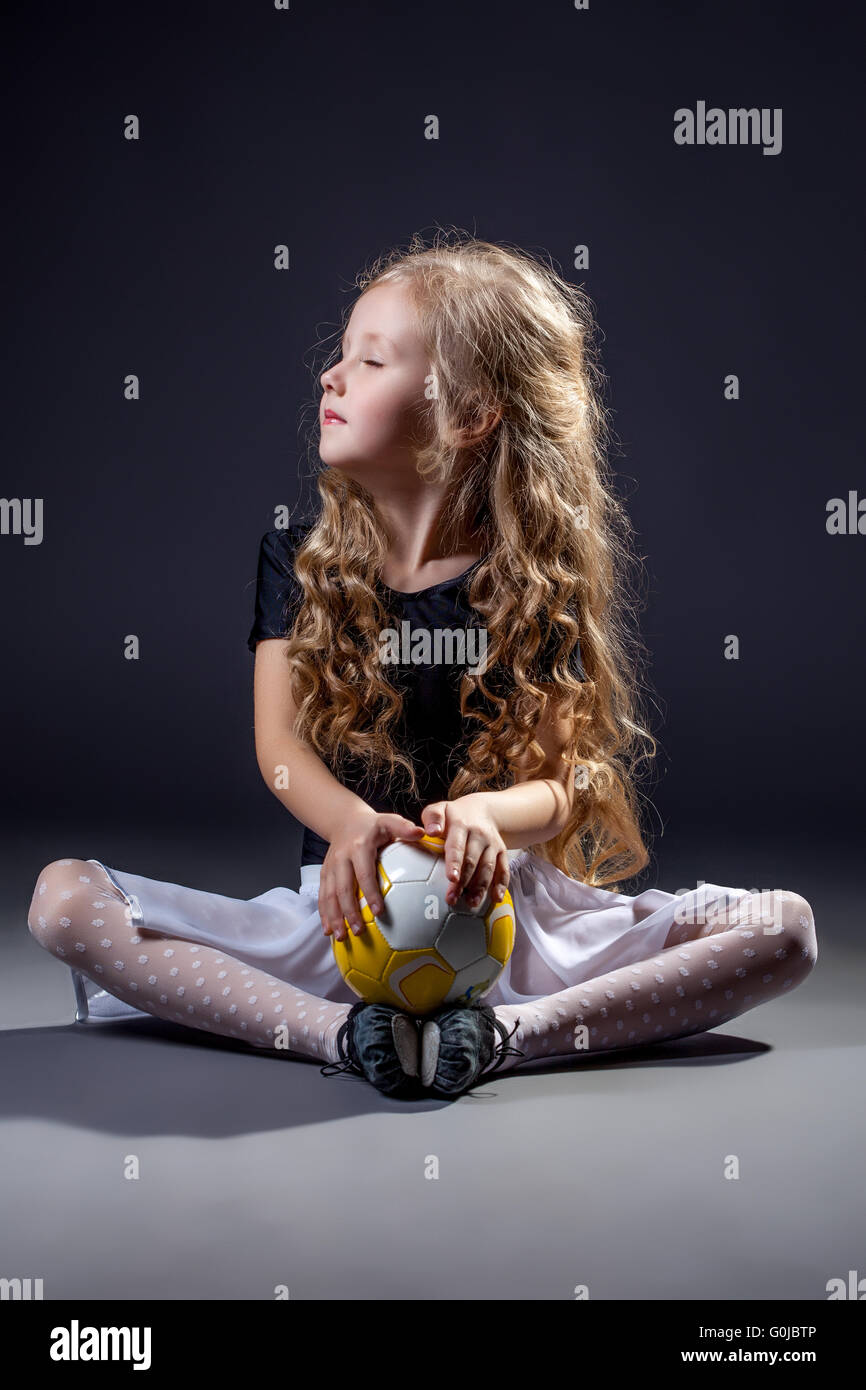Cute curly-haired little girl posing with ball Stock Photo - Alamy Cute curly-haired little girl posing with ball Stock Photo - Alamy