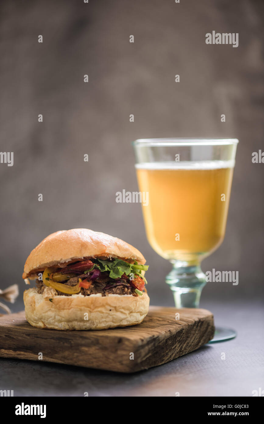 BBQ beef bun and glass of Ale local beer or cider Stock Photo - Alamy