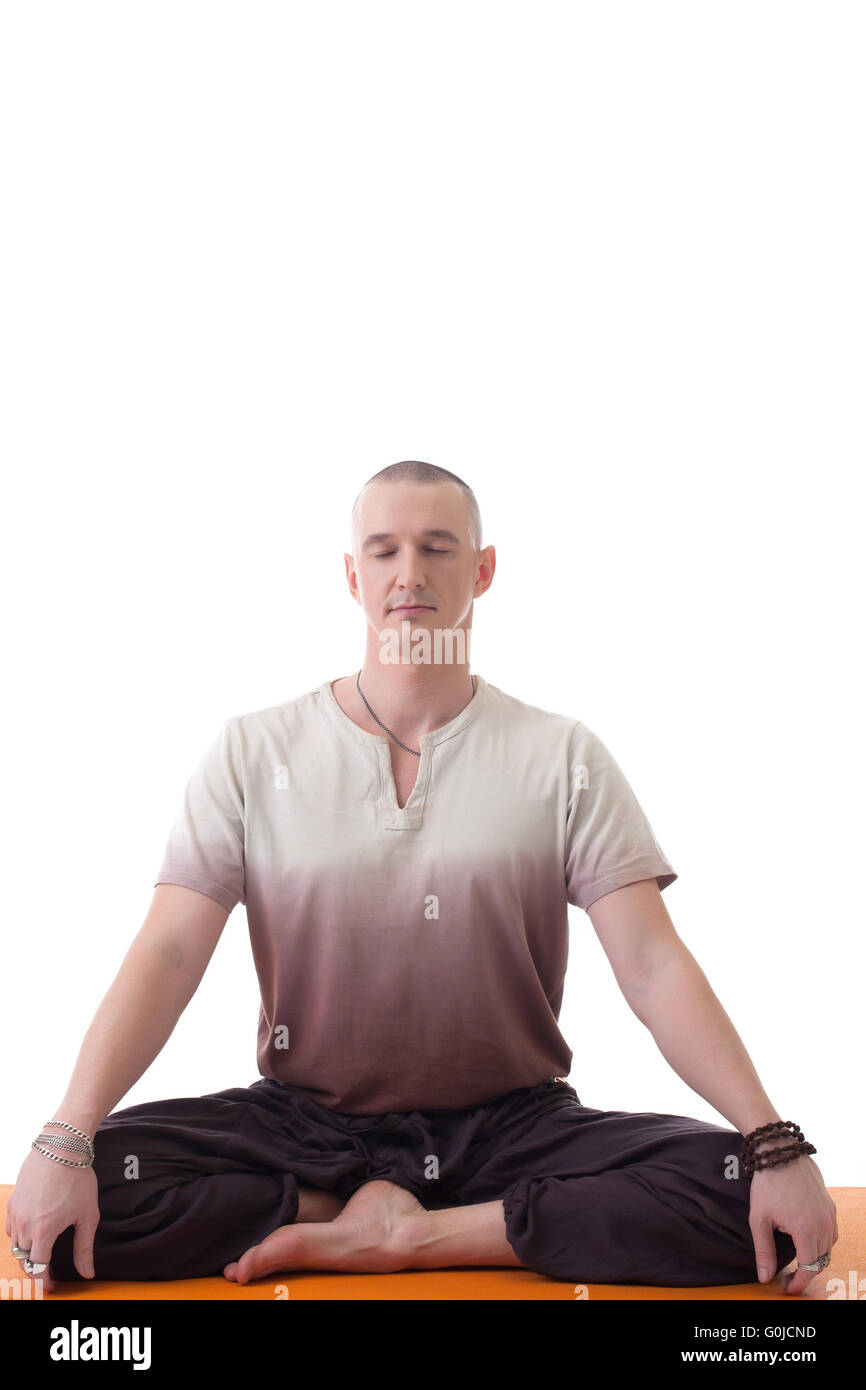 Attractive meditator man posing in lotus posture Stock Photo - Alamy