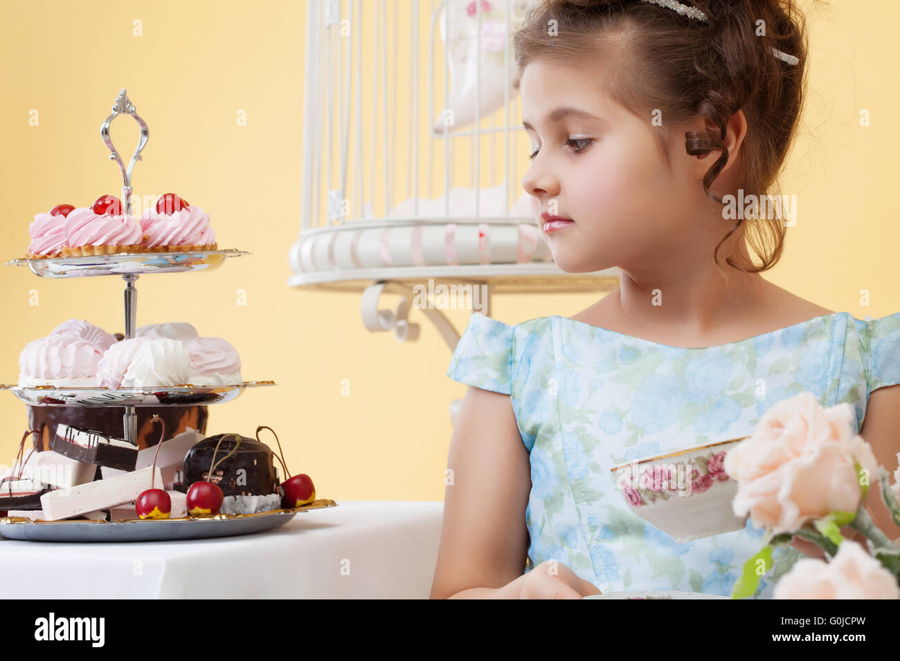 Portrait of pretty smart girl looking at sweets Stock Photo - Alamy