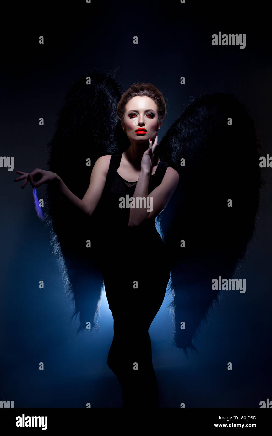 Beautiful model posing in suit of fallen angel Stock Photo - Alamy