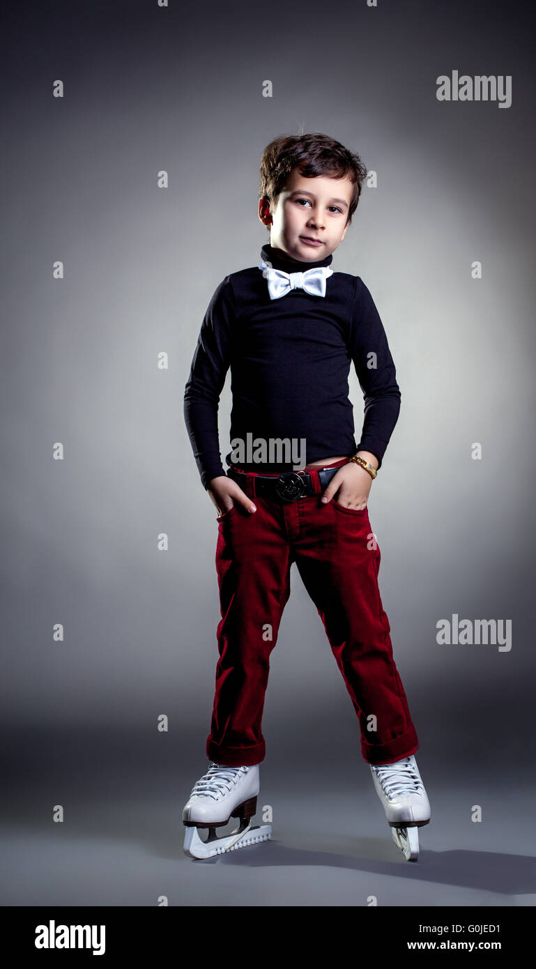 Trendy dressed boy posing ice skating in studio Stock Photo - Alamy