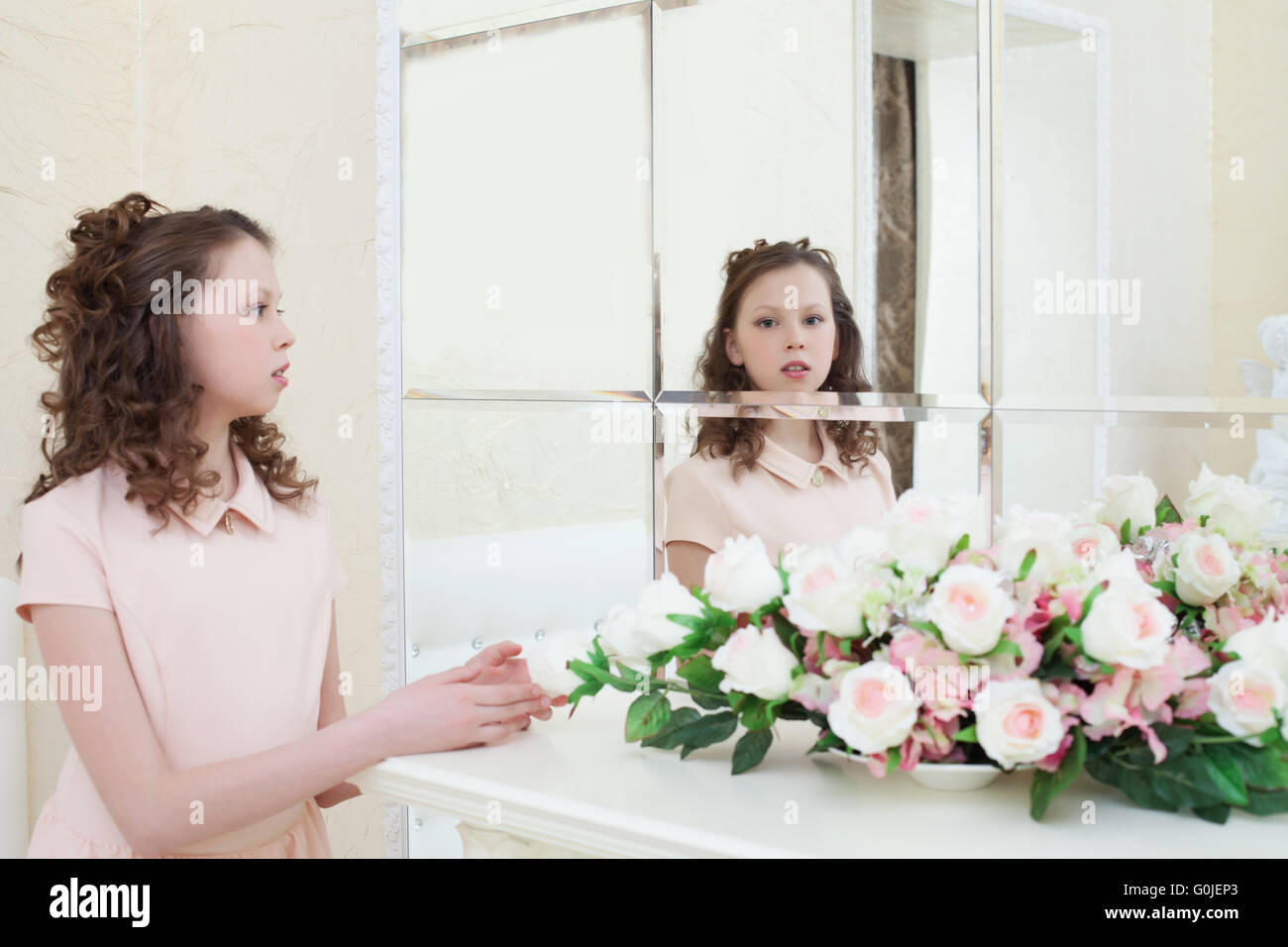 Cute little girl admiring her reflection in mirror Stock Photo - Alamy