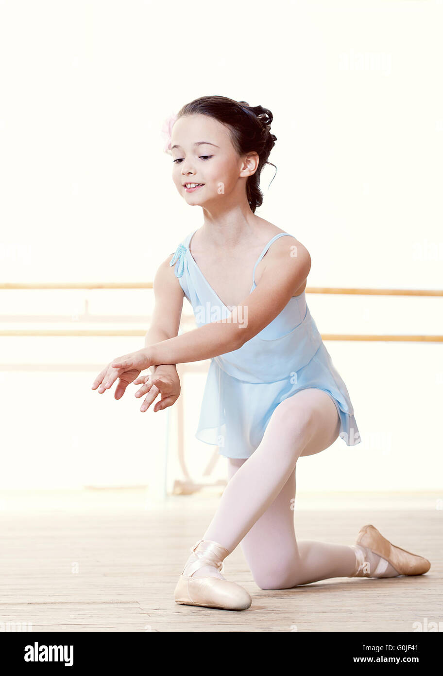Little dancer doing exercises in ballet studio Stock Photo - Alamy