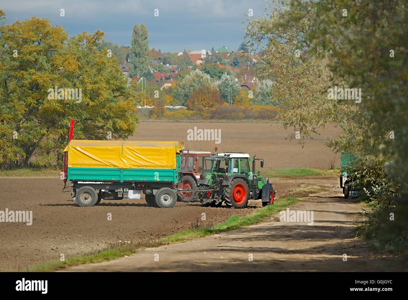 Tractors working on a field Stock Photo - Alamy