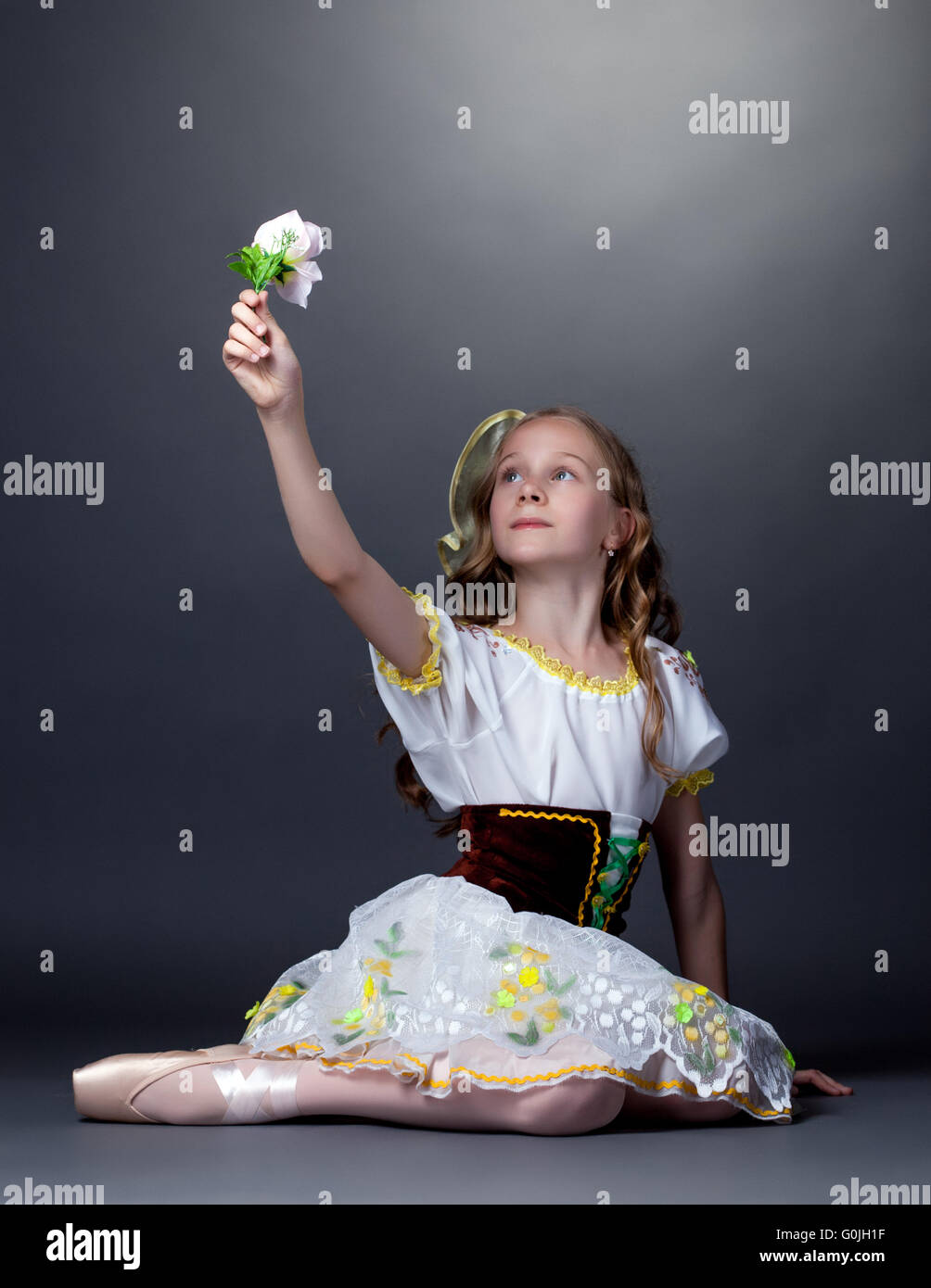 Emotional ballet dancer posing looking at flower Stock Photo - Alamy