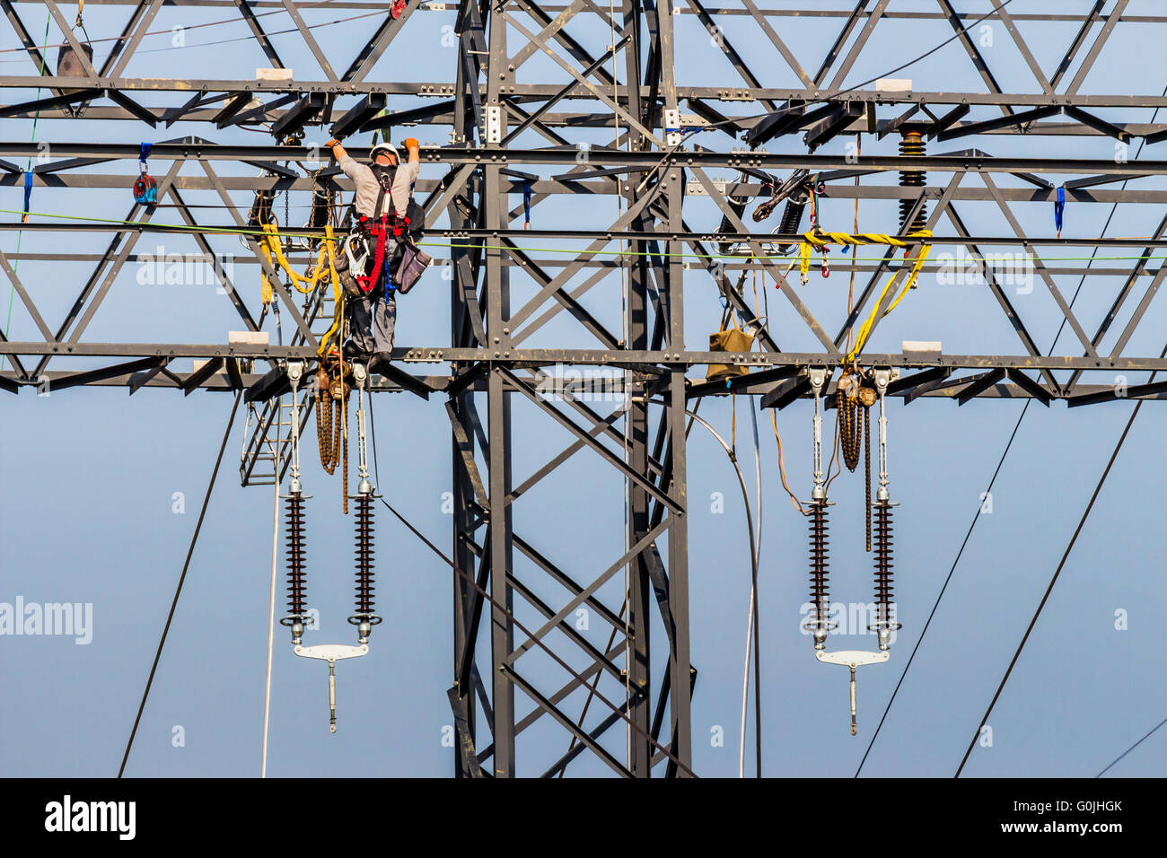 working on a power poles Stock Photo - Alamy