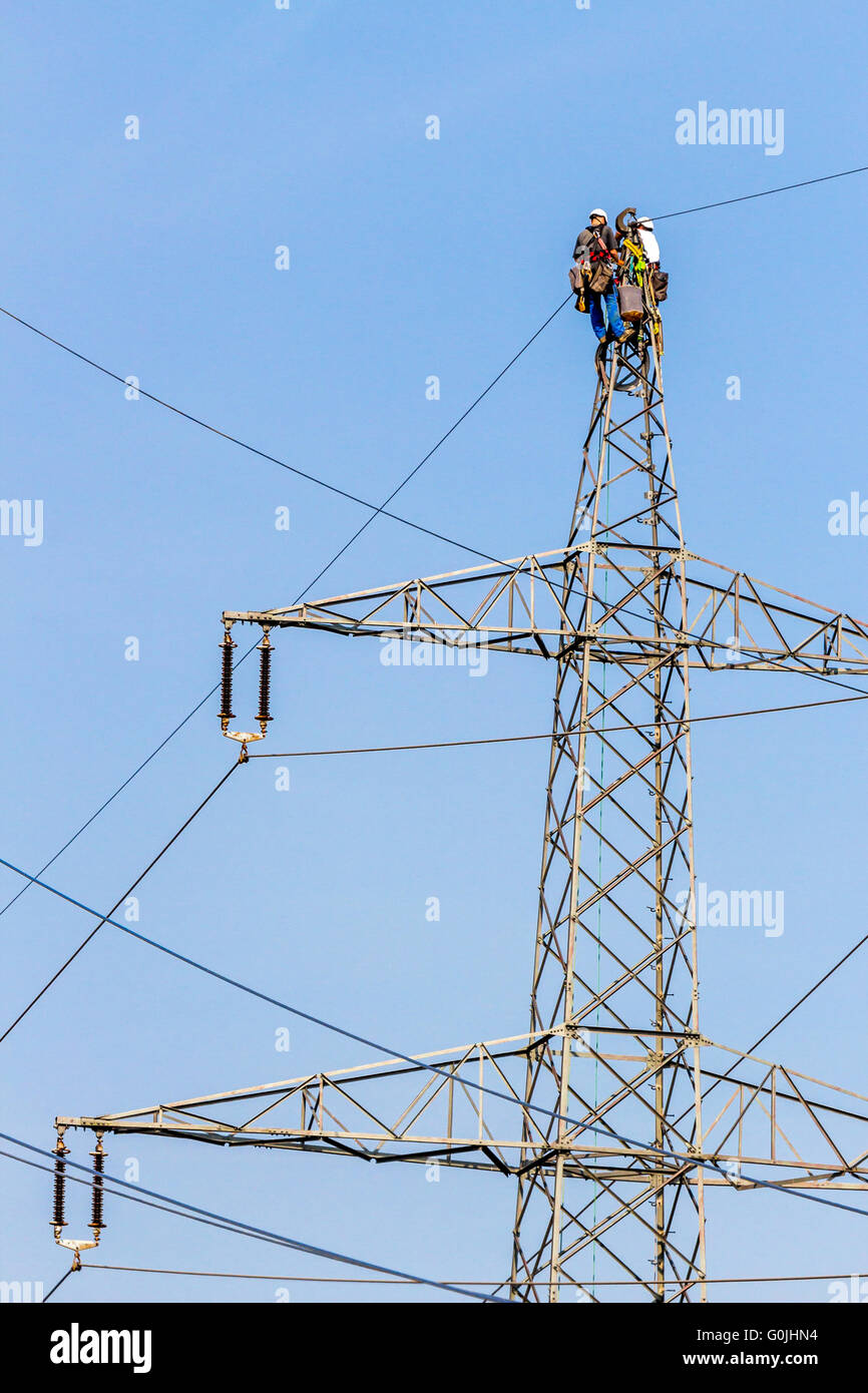 working on a power poles Stock Photo - Alamy