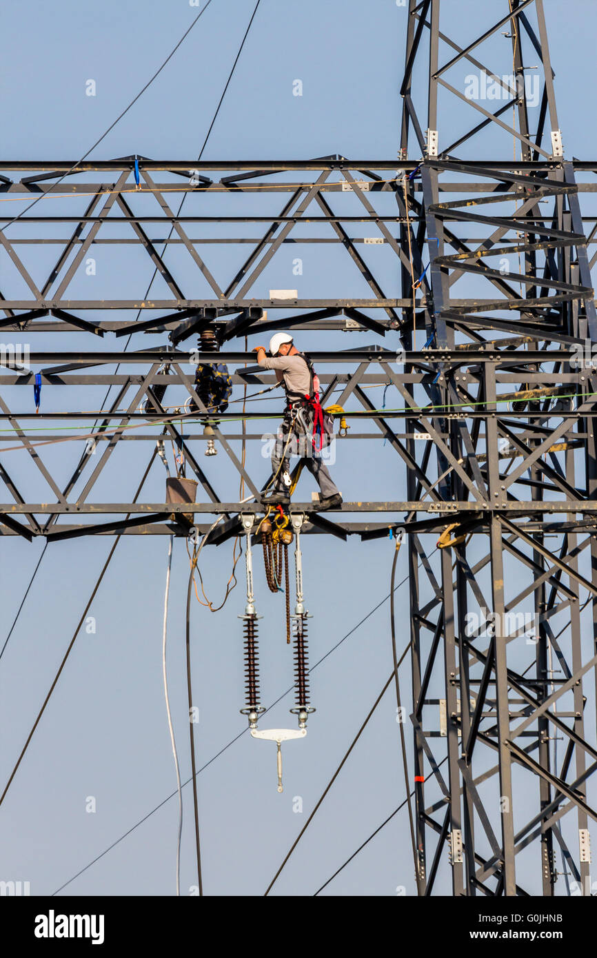 working on a power poles Stock Photo - Alamy