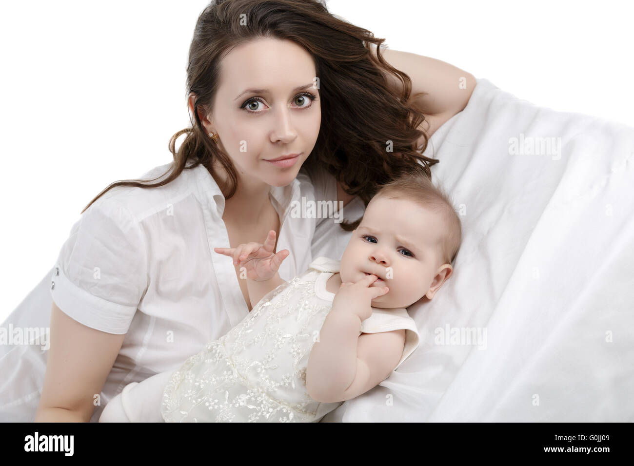 Pretty mother and her sweet baby posing in studio Stock Photo - Alamy