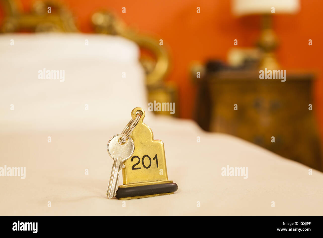 Hotel Room Key lying on Bed with keyring Stock Photo - Alamy