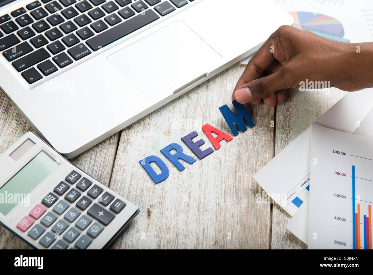 Hand arranging dream with financial concepts Stock Photo - Alamy