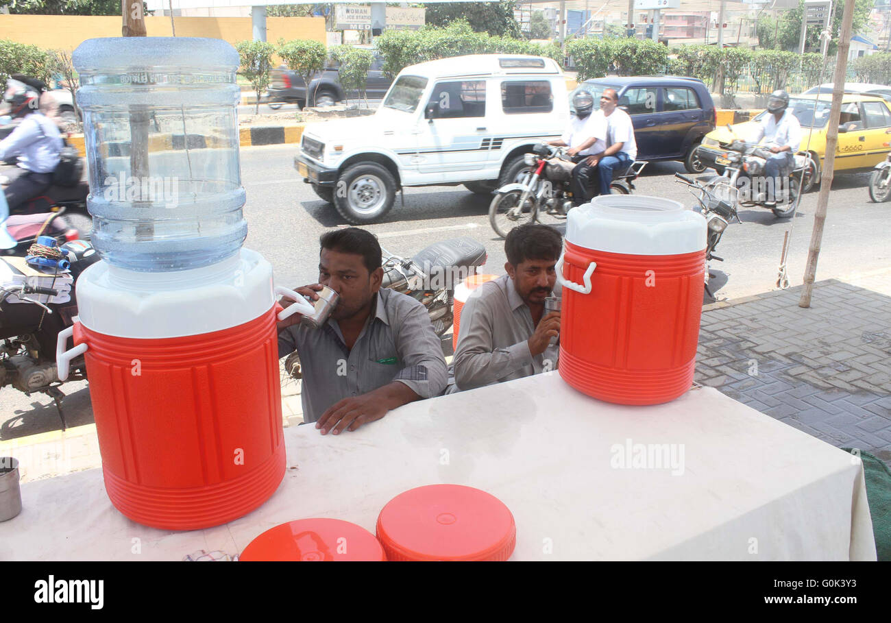 People are drinking chilled water to beat the heat of sun at a camp ...