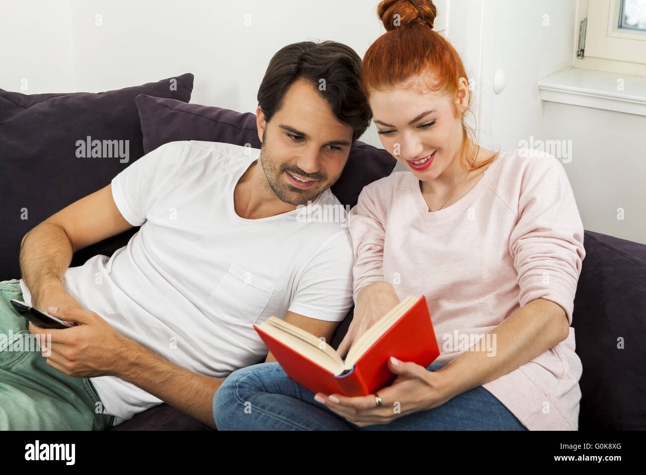 Couple Resting on the Sofa at the Living Room Stock Photo - Alamy