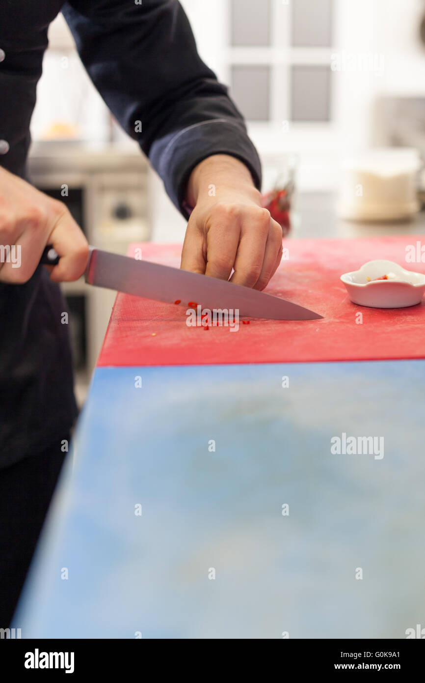 Chef dicing red hot chili peppers Stock Photo - Alamy