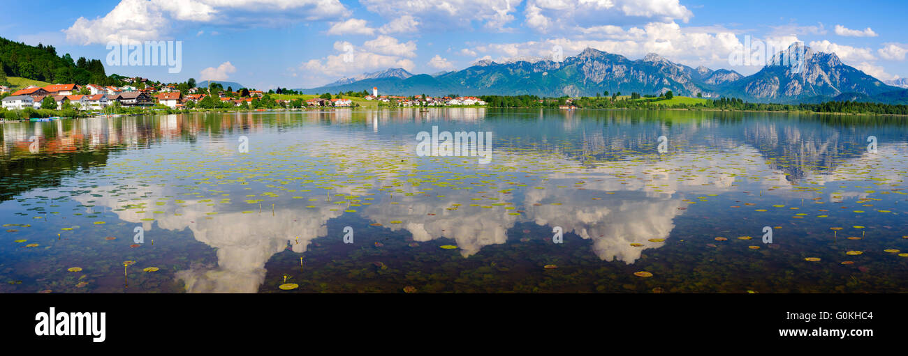 panorama landscape in Bavaria with lake Hopfensee and alps mountains ...