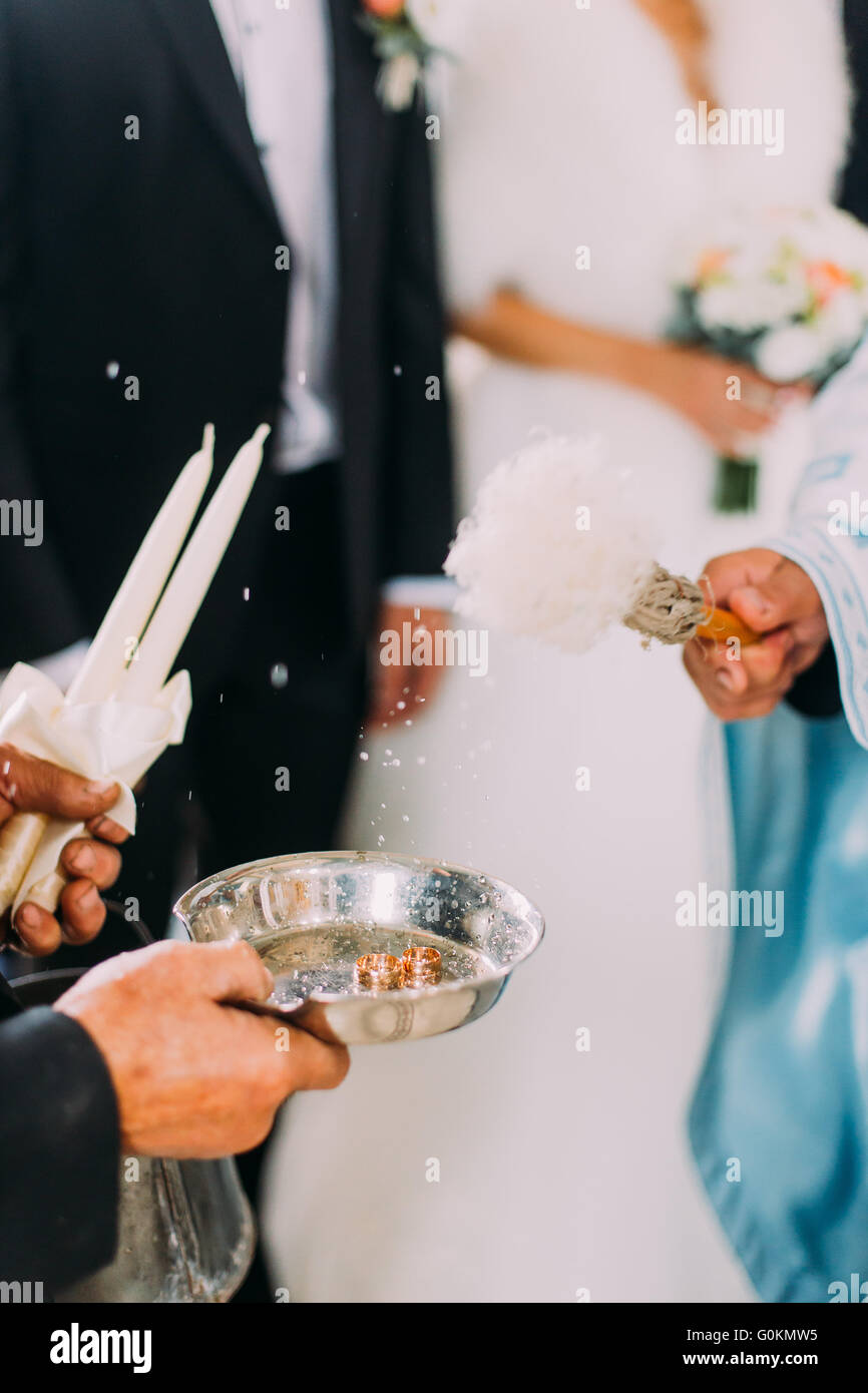 Priest blessing luxury wedding rings in the old church Stock Photo - Alamy