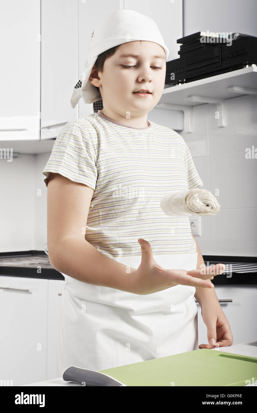 Boy throwing dough up Stock Photo - Alamy