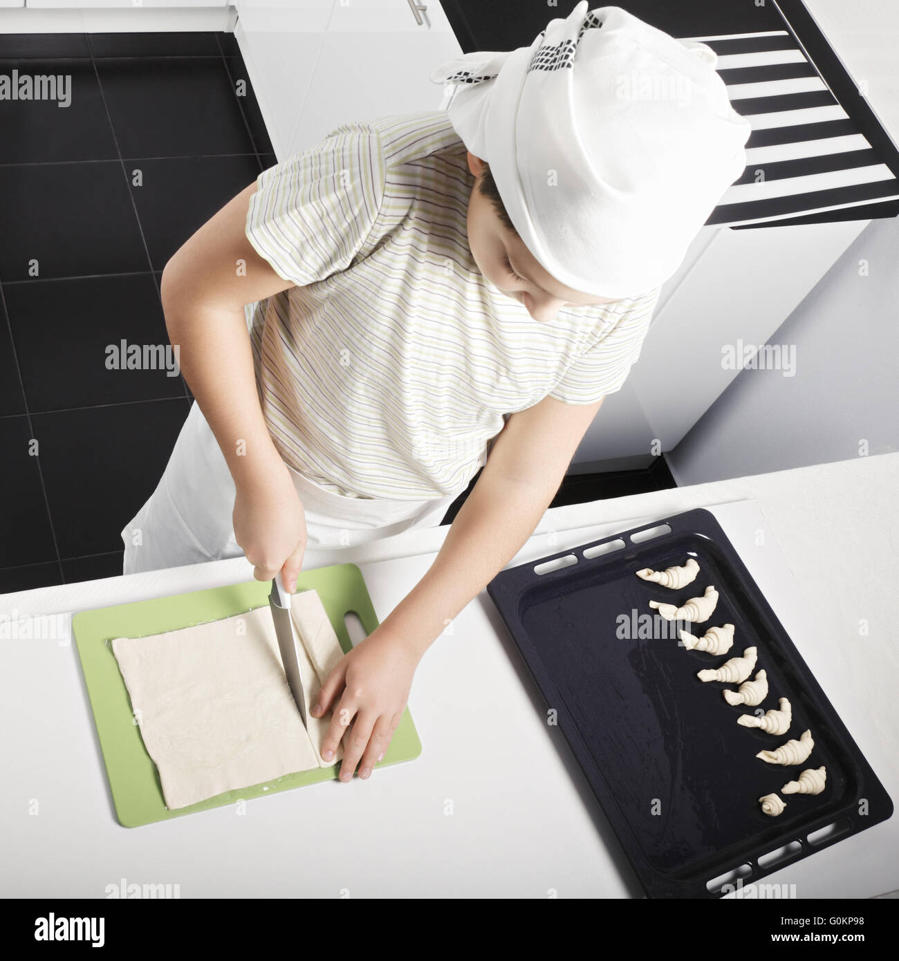 Boy cutting dough Stock Photo - Alamy