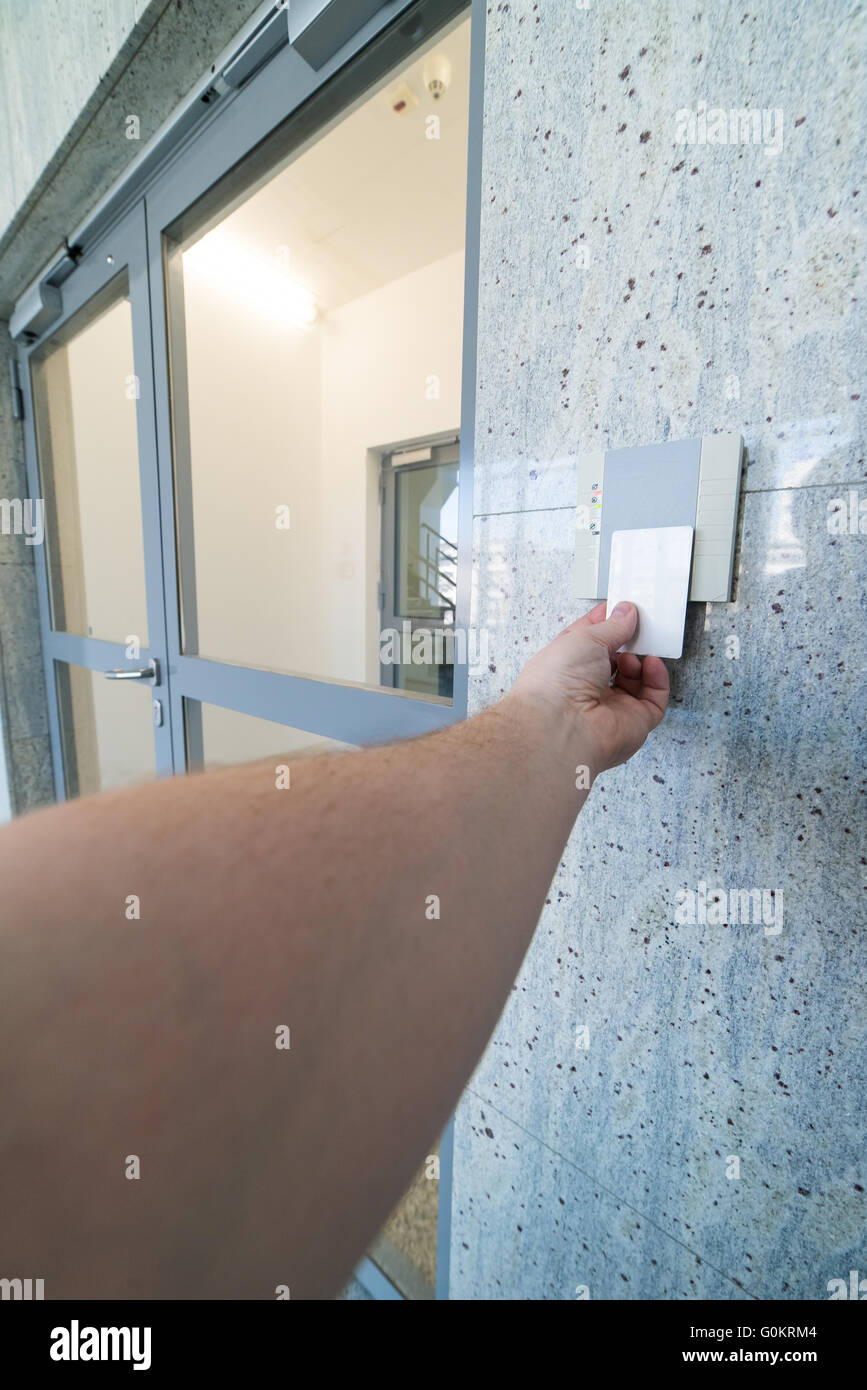 man puts the card into the card reader access Stock Photo - Alamy